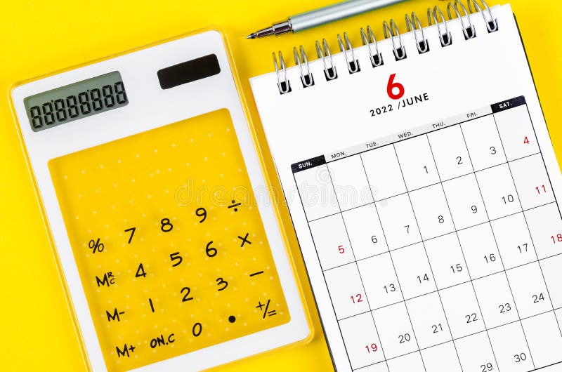 June 2022 Desk Calendar with Calculator and Pen on Yellow Background ...