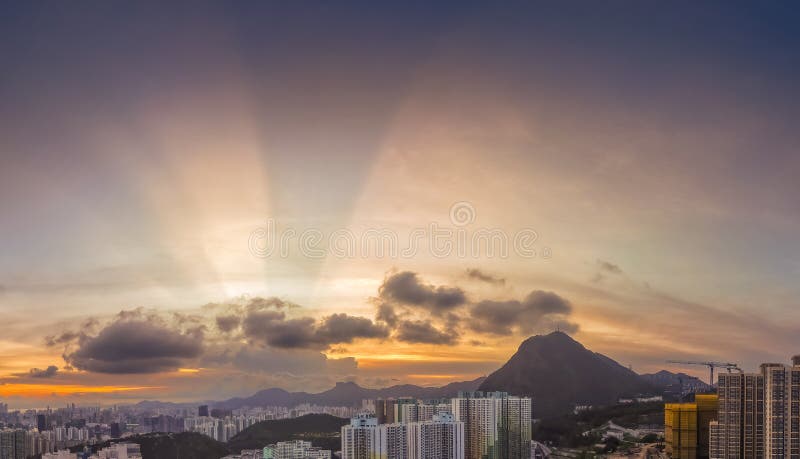 June 8 2025 Dramatic Sunset Over City Skyline with Radiating Sun Rays ...