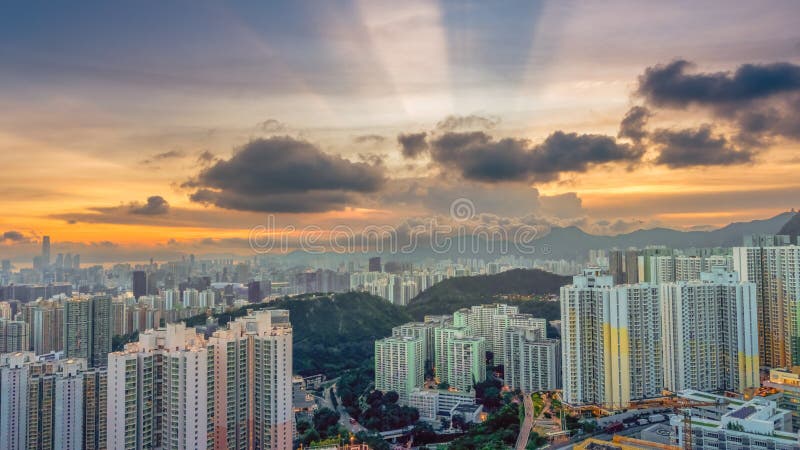 June 8 2025 Dramatic Sunset Over City Skyline with Radiating Sun Rays ...