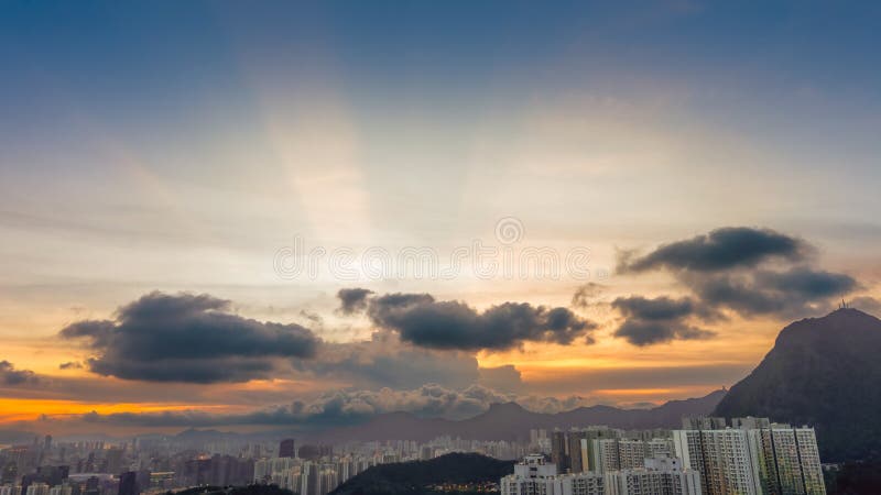 June 8 2025 Dramatic Sunset Over City Skyline with Radiating Sun Rays ...