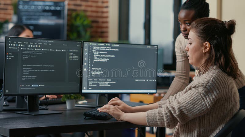 Junior Developer Sitting Down on Desk Showing Laptop with Source Code To Senior Dev Stock Image ...