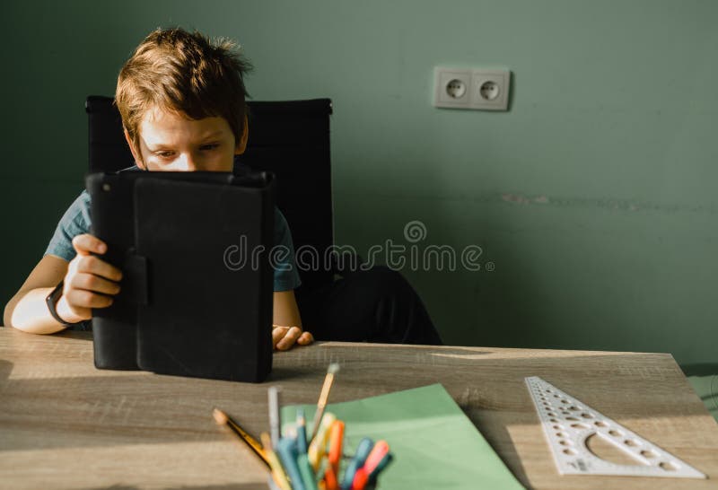 Junior School Boy Using Tablet At Home, Growing Up With Technology ...
