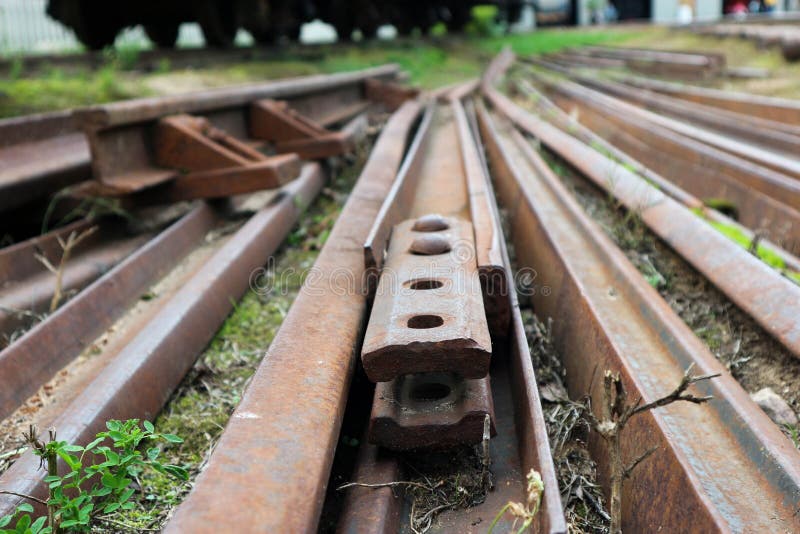 Junkyard of Old Rusty Railroad Tracks on the Grass Stock Photo - Image ...