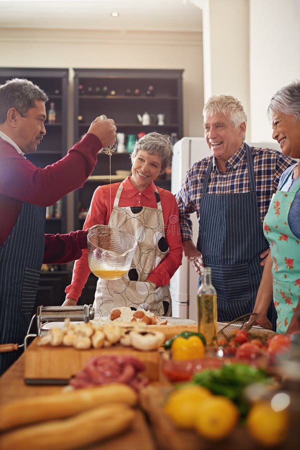 Just Beat it. a Group of Seniors Cooking in the Kitchen. Stock Photo ...