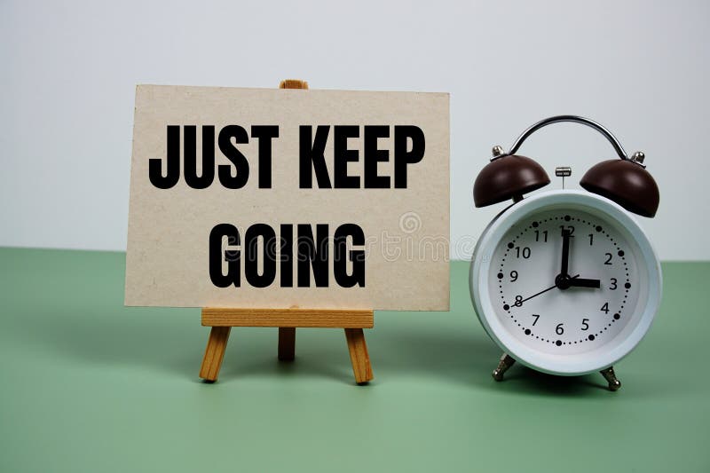 Just Keep Going Text on Paper Card with Alarm Clock on Green Background Stock Image - Image of ...