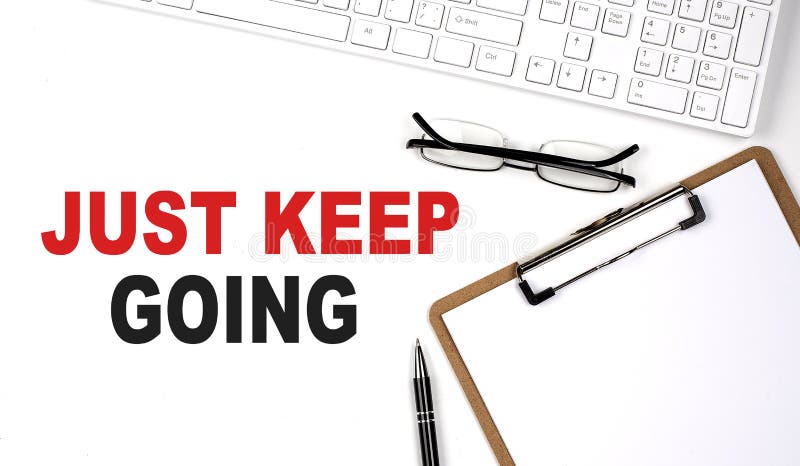 JUST KEEP GOING Text Written on the White Background with Keyboard ...