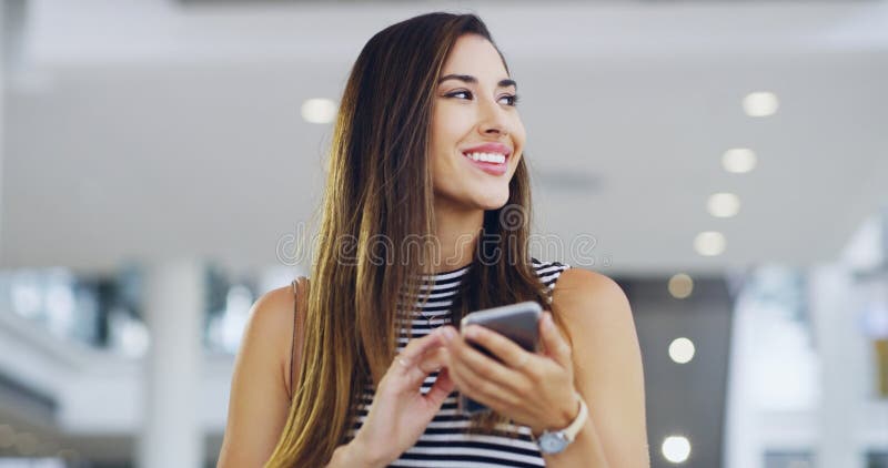 That Just Might Work...a Young Businesswoman Using a Smartphone while ...