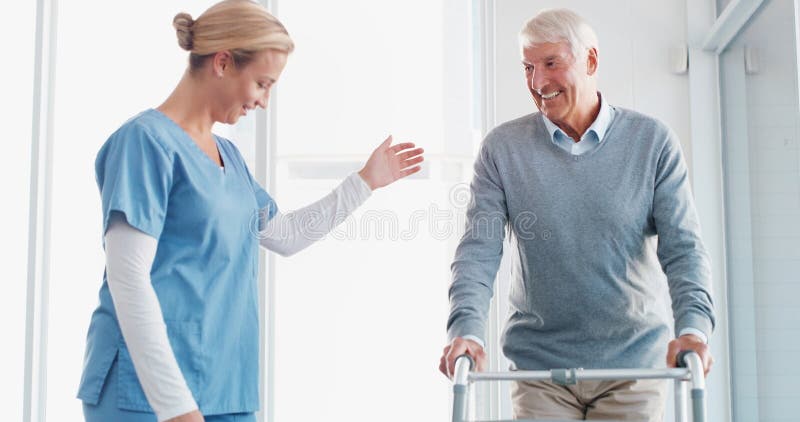 Just One More Step...a Senior Man Using a Walker with the Assistance of ...