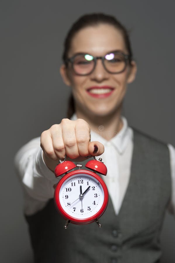 Charming Young Businesswoman or Office Worker Holding Red Clock in ... Charming Young Businesswoman or Office Worker Holding Red Clock in ...