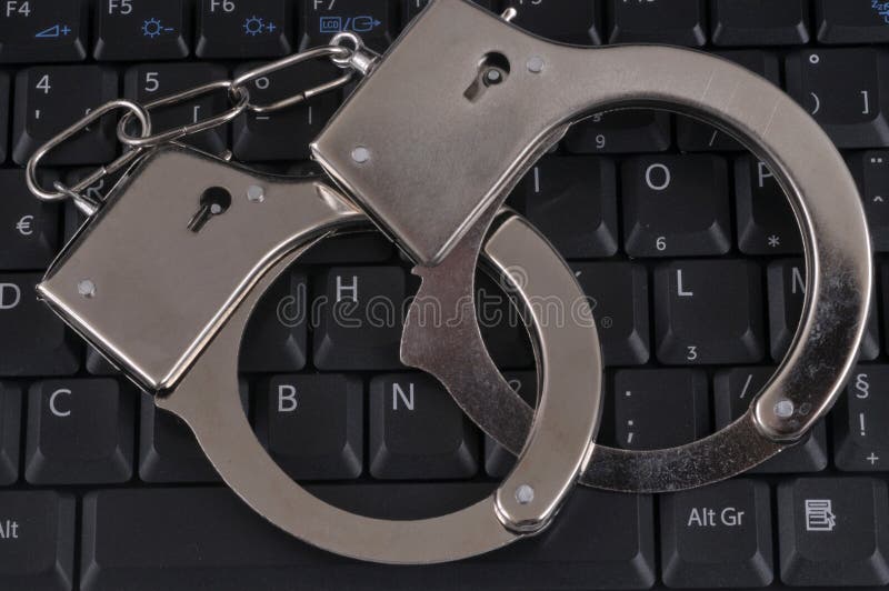 Handcuffs Close Up on a Computer Keyboard Stock Photo - Image of ...