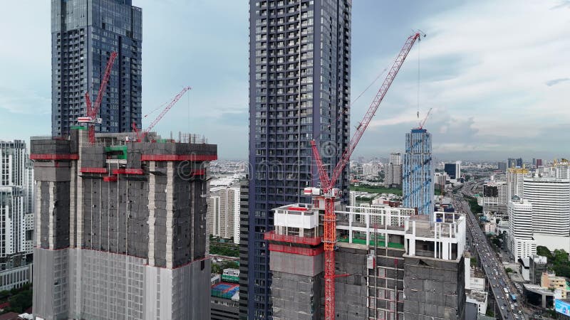 4K Aerial View of Construction Site with Crane at High Rise Buildings ...