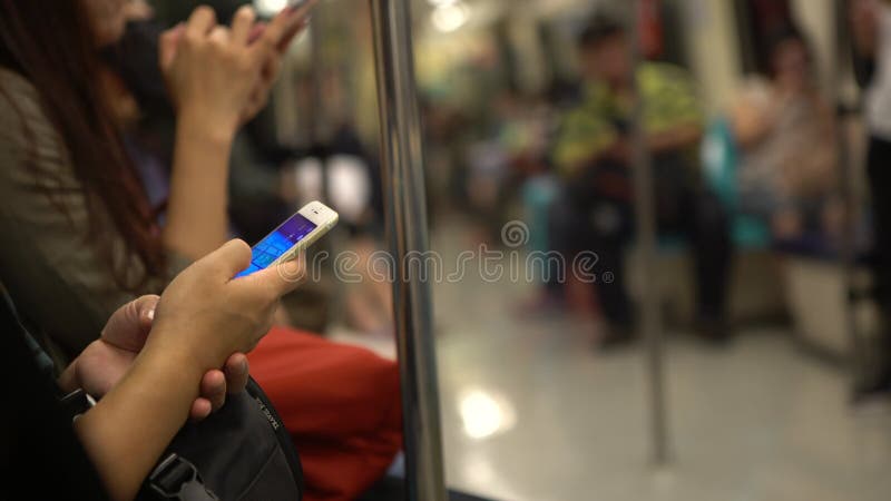 4K Asian People Sit Down in the Train Using Smartphone for Play Same ...