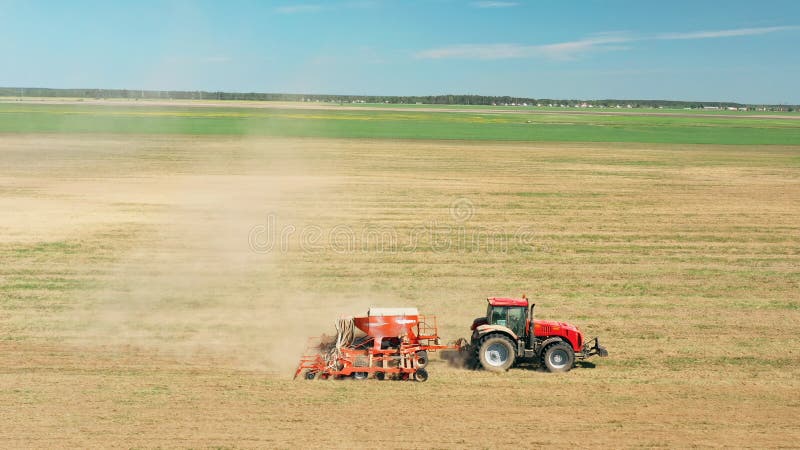 4K Elevated View Tractor with Seed Drill Machine Sowing the Seeds for ...