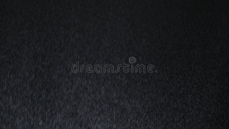 4k Heavy Angled Rain Falling in Front of the Camera Against Black ...