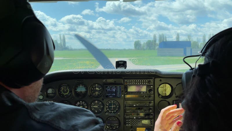 4k Pilots in a Cockpit Ready for Flight. Pilot Checking Headphones ...