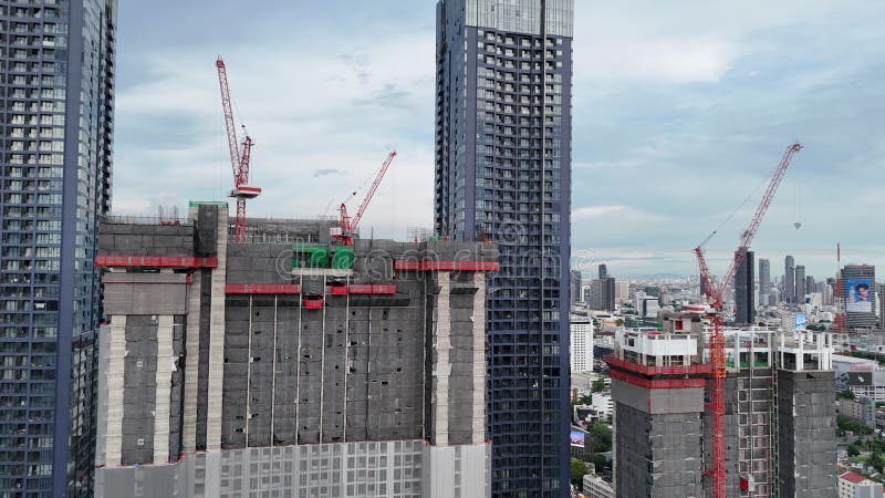 4K Tower Cranes on Top of Skyscraper with City Background Stock Footage ...