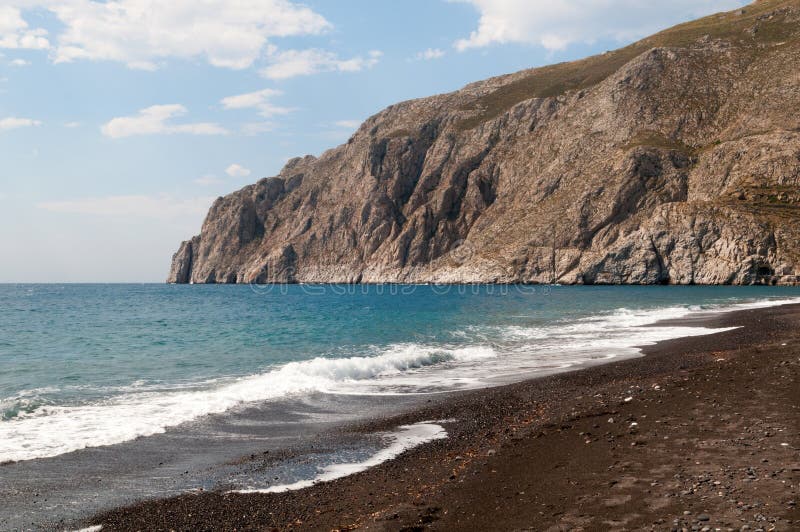 Kamari Beach stock photo. Image of boat, black, rock - 71683726