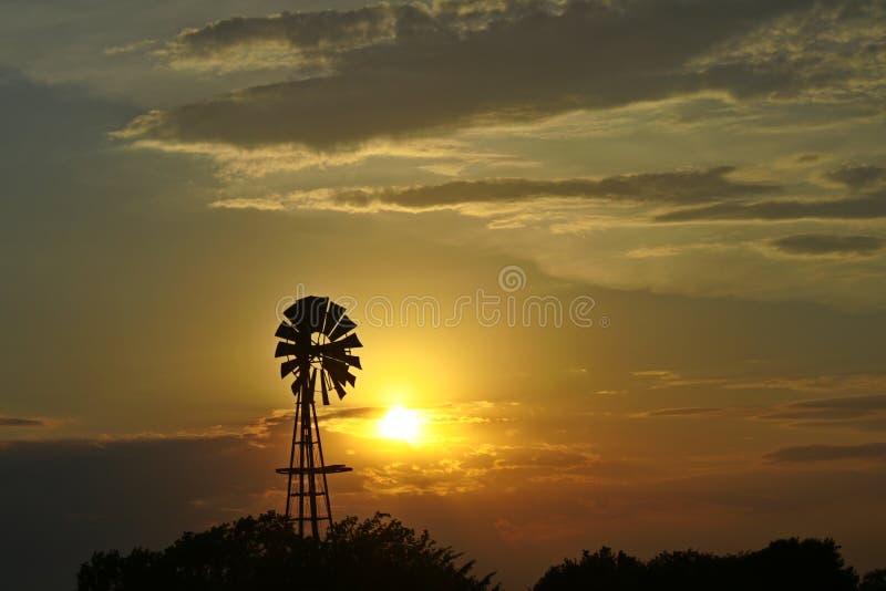 Kansas Windmill Sunset with Clouds and the Sun Stock Photo - Image of ...
