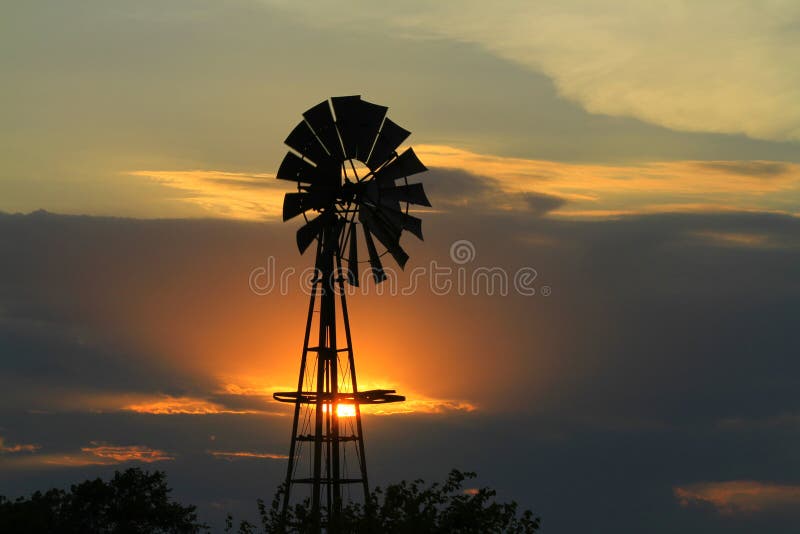 Kansas Windmill Sunset with Clouds and the Sun Stock Image - Image of ...