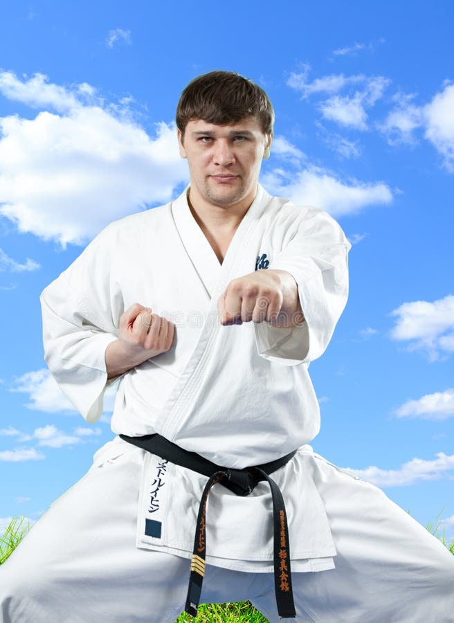 Karate Master in Kimono on Blue Sky Stock Image - Image of adult, fist ...