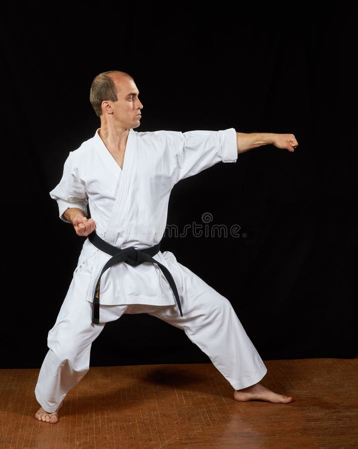 In a Low Karate Stand, an Athlete Does Formal Karate Exercises Stock ...