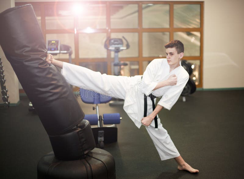 Karate. a Young Man is Practicing Kicking, Training in the Gym Stock ...