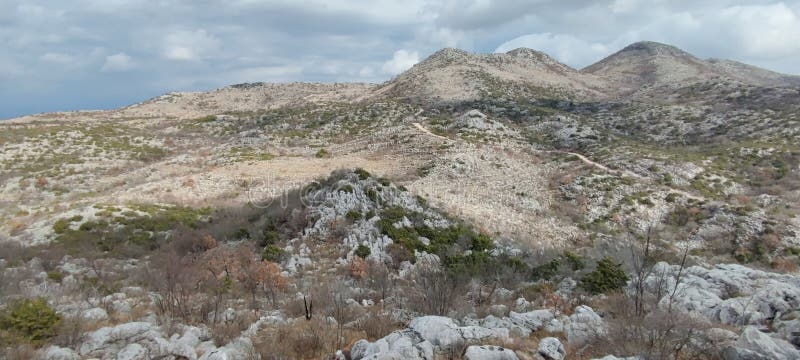 Karst Landscape with Rugged Rocks and Sparse Vegetation Stock Photo ...