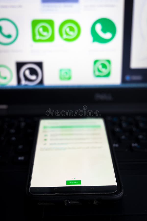 WhatsApp Terms of Service on a Smartphone Against a PC Computer ...