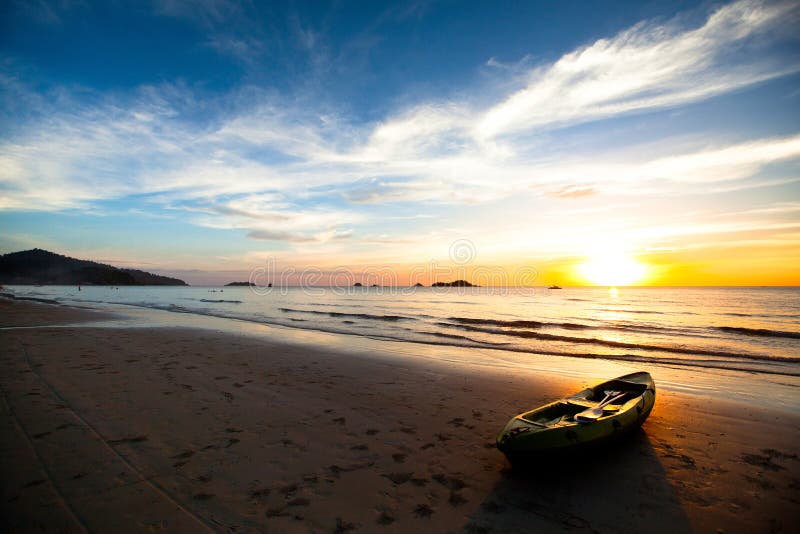 Canoe on the Ocean Beach during the Amazing Sunset. Stock Photo - Image ...
