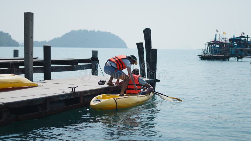 Kayak Instructor Helping a Beginner Prepare To Paddle on the Harbor ...