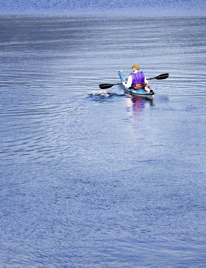 Kayaker paddling on lake stock photo. Image of paddling - 2937994