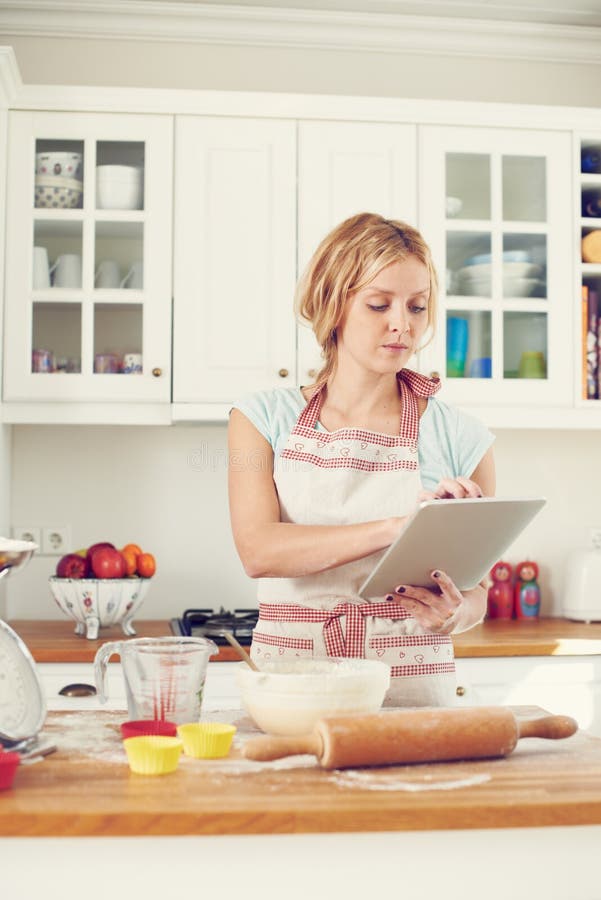 Keep Calm and Bake on. a Young Woman Baking in Her Kitchen. Stock Photo ...