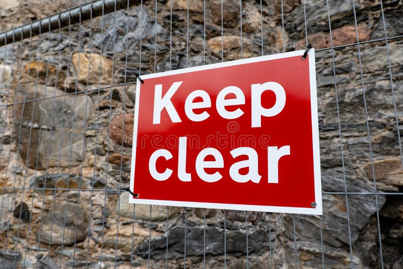 Keep Clear Warning Sign on a Metal Fence during Reconstruction of a ...