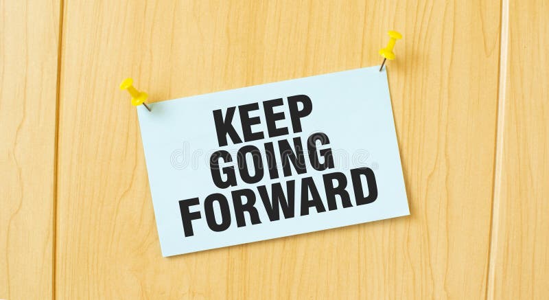 KEEP GOING FORWARD Sign Written on Sticky Note Pinned on Wooden Wall ...