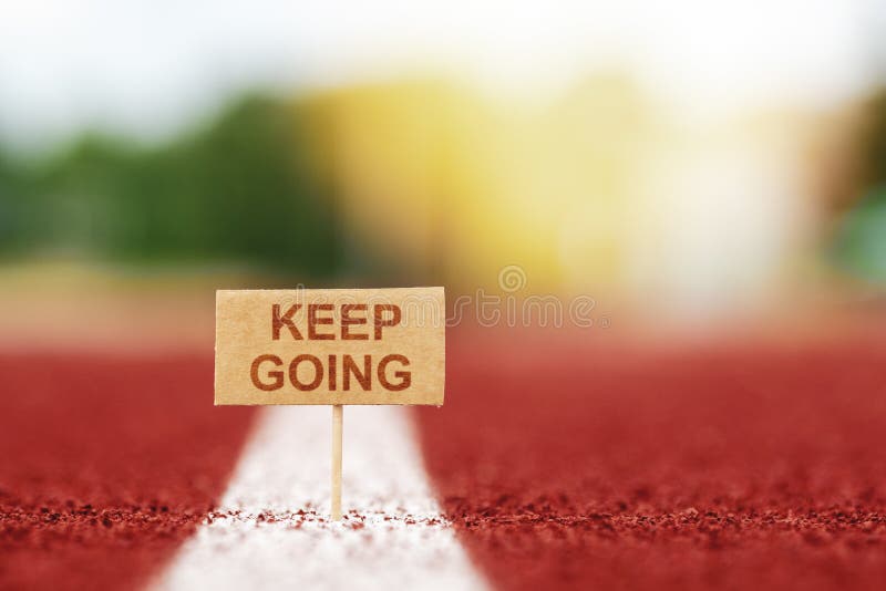 KEEP GOING Writing on a Text Sign on a Running Track Stock Photo ...