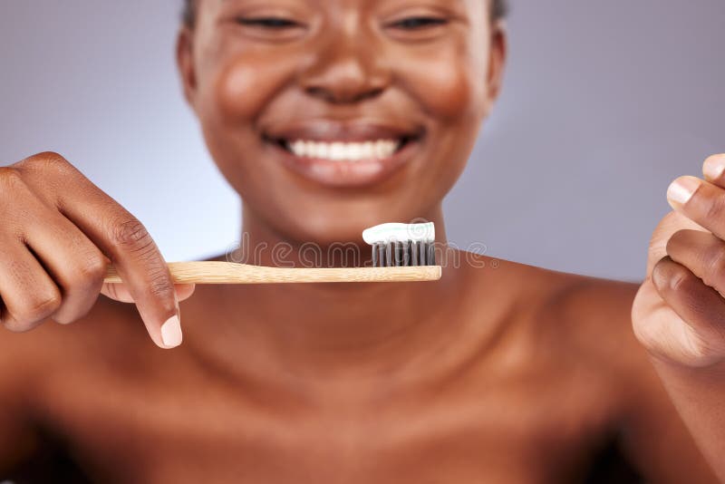 Keep a Healthy Smile. Studio Shot of a Beautiful Young Woman Brushing ...