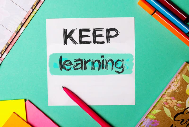 KEEP LEARNING Written on a Turquoise Background Near Bright Stickers ...