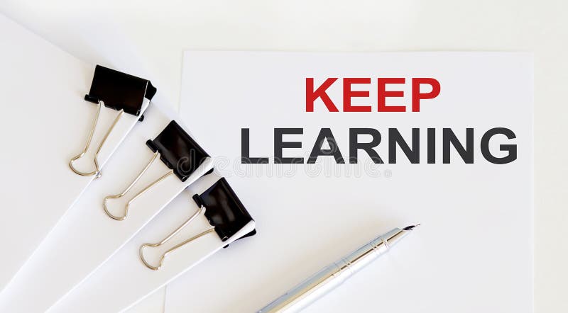 KEEP LEARNING Written on a White Page with Office Tools Stock Image ...