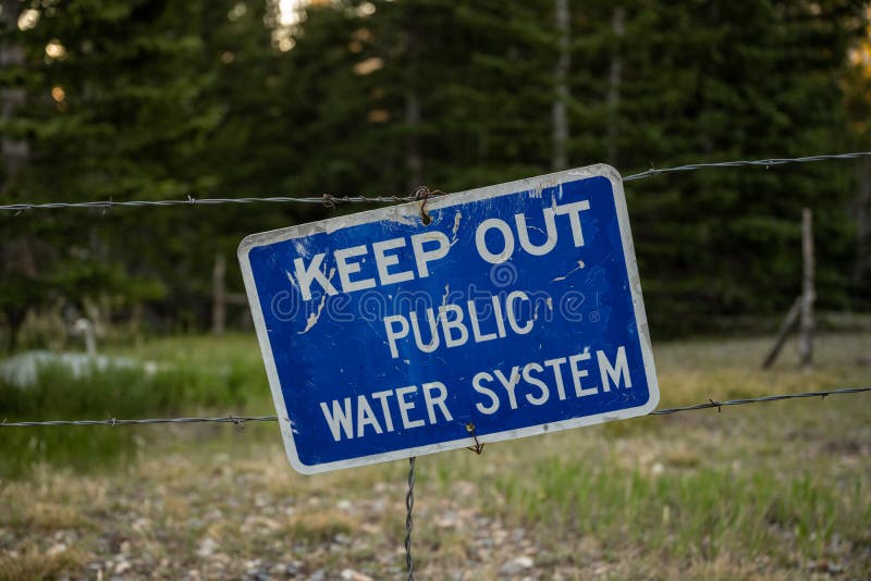 Keep Out of Public Water System Sign Stock Photo - Image of fence ...