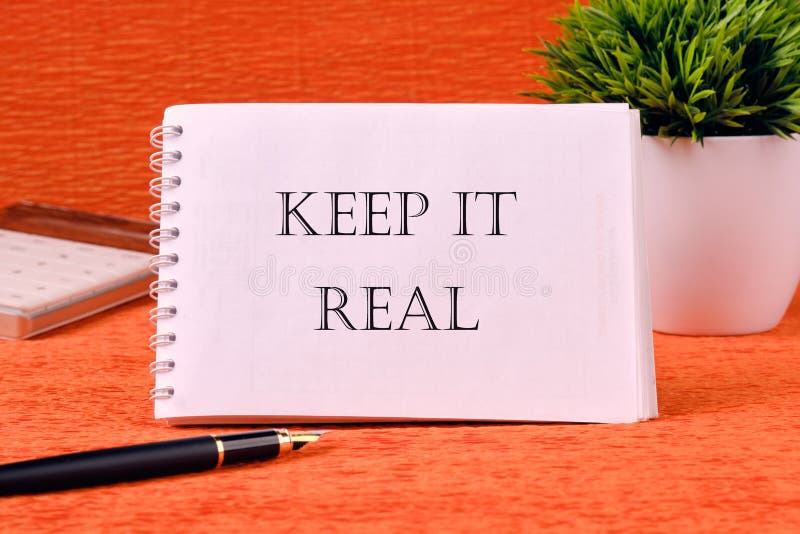 KEEP it REAL Text on a White Notebook on an Orange Background Stock ...