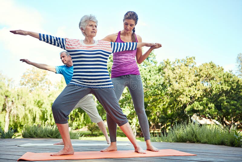 Keep in Shape No Matter Your Age. a Yoga Instructor Guiding a Senior ...