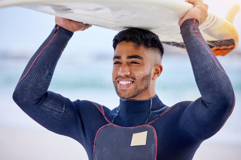 Keep it Simple - Surf More. a Handsome Young Man Carrying a Surfboard ...