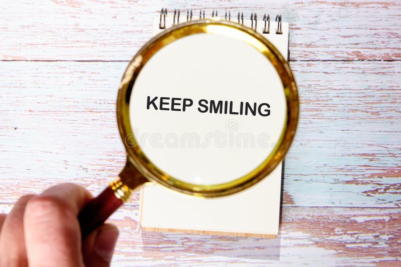 KEEP SMILING Words Cognized with a Magnifying Glass in a Blank Notebook ...