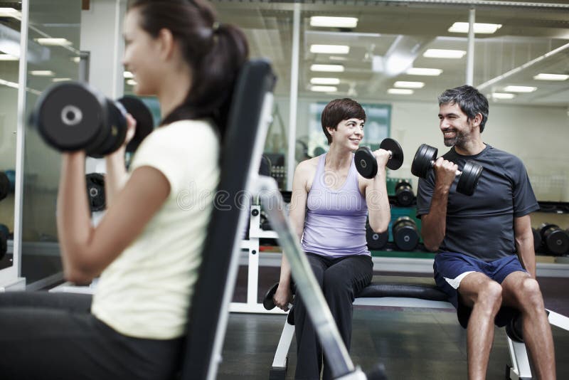 Keep Up Hey. People Working Out Using Dumbbells in the Gym. Stock Image ...