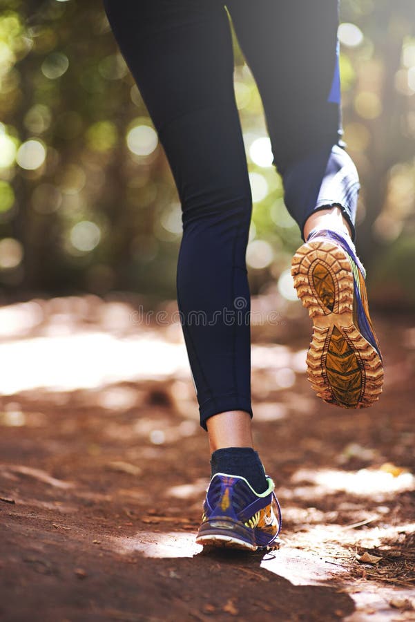 Keep Up the Pace. Low Angle View of a Woman Running on a Trail. Stock ...