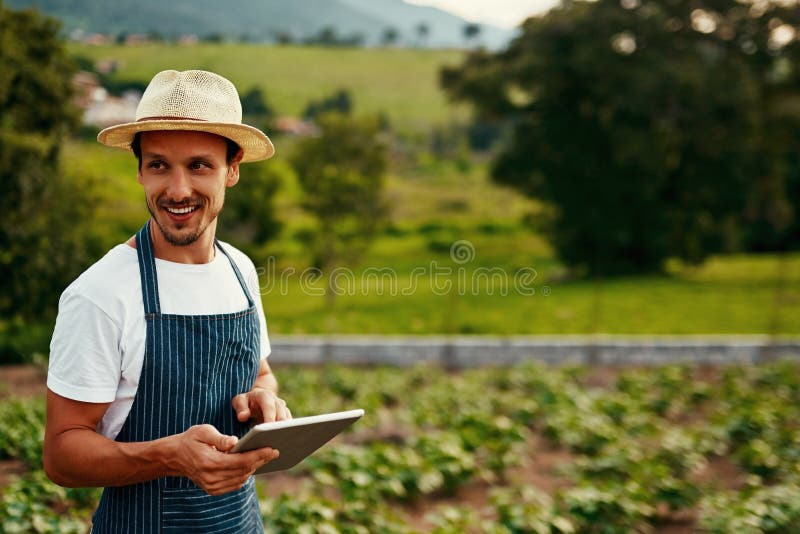 Keeping a Close Eye on His Farm. a Handsome Young Man Using a Tablet ...