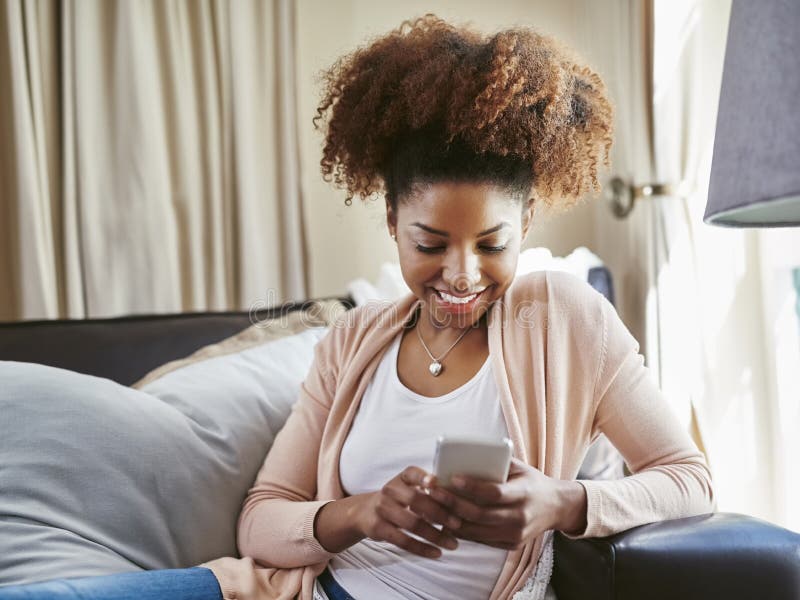 Keeping in Contact. an Attractive Young Woman Using Her Cellphpone ...