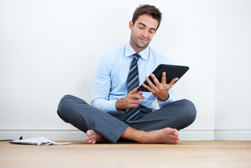 Keeping Current after a Day at Work. a Barefoot Businessman Sitting on ...