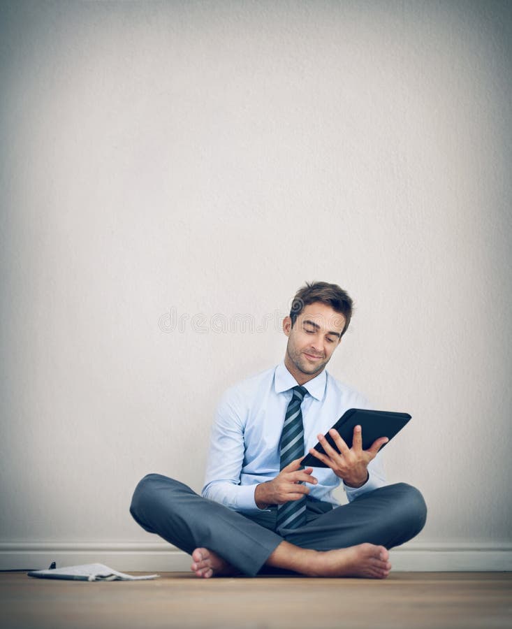 Keeping Current after a Day at Work. a Barefoot Businessman Sitting on ...