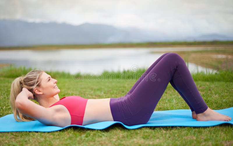 Keeping Her Core Muscles Strong. Shot of a Young Woman Doing Sit-ups in ...